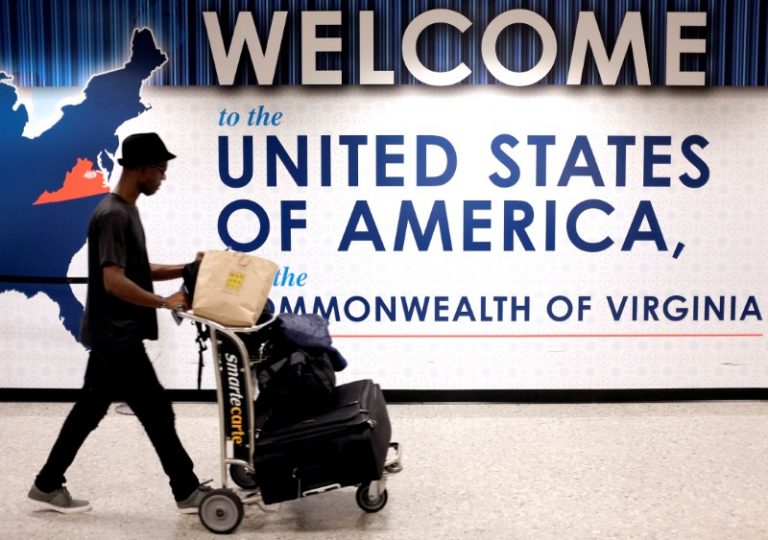 FILE PHOTO: A man exits the transit area after clearing immigration and ...