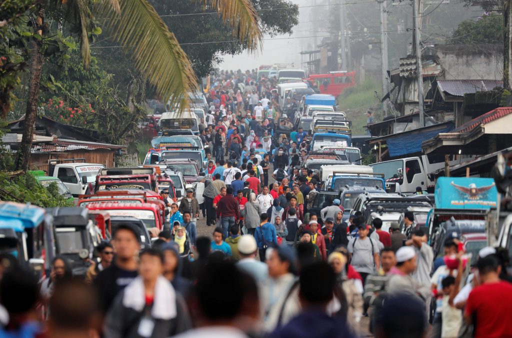 Teary-eyed, hundreds search through rubble in devastated Philippines city